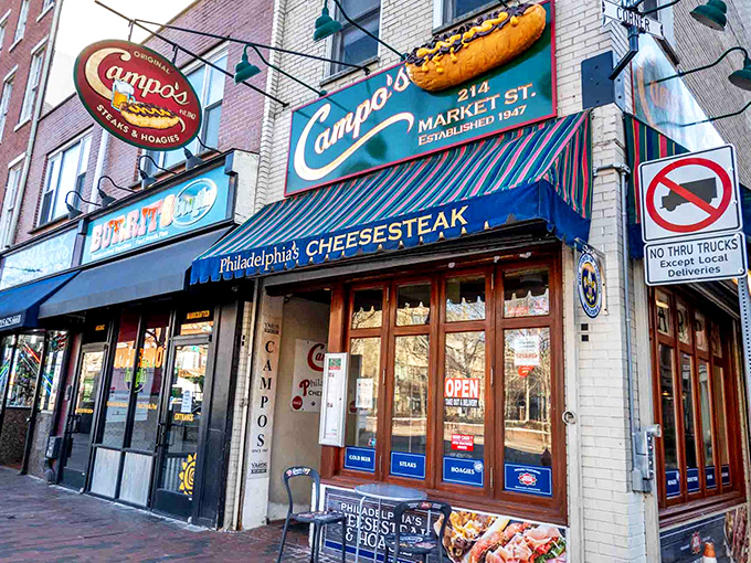The iconic blue awning of Campo's beckons hungry pilgrims like a culinary lighthouse on Market Street, promising cheesesteak salvation to all who enter.