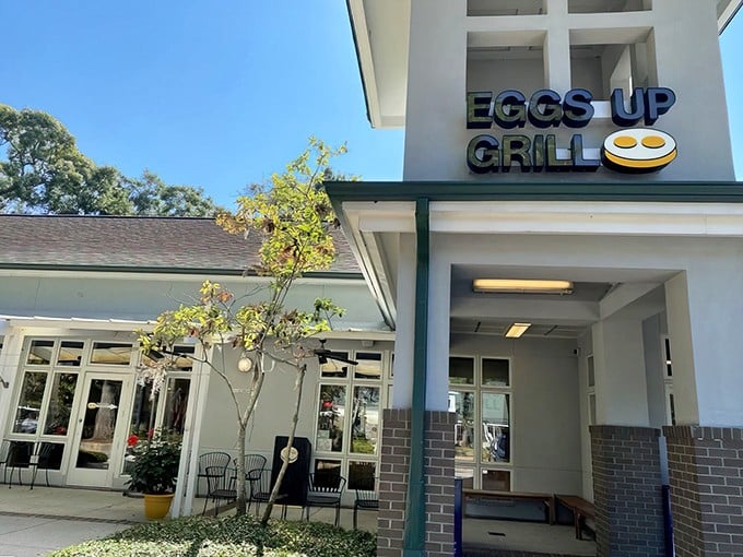 Spanish moss frames this breakfast haven like nature's own welcome sign. Pawleys Island's Eggs Up Grill promises morning magic beneath Carolina blue skies.