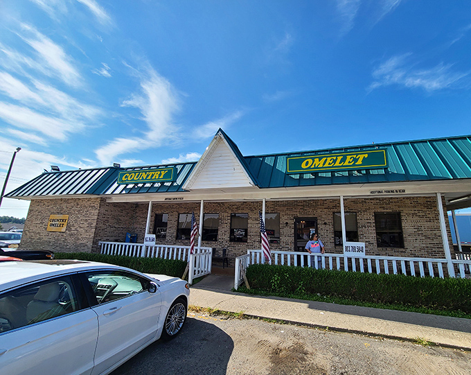 The unassuming exterior with its distinctive green roof and white picket fence might not scream "food destination," but locals know better. Breakfast paradise awaits!
