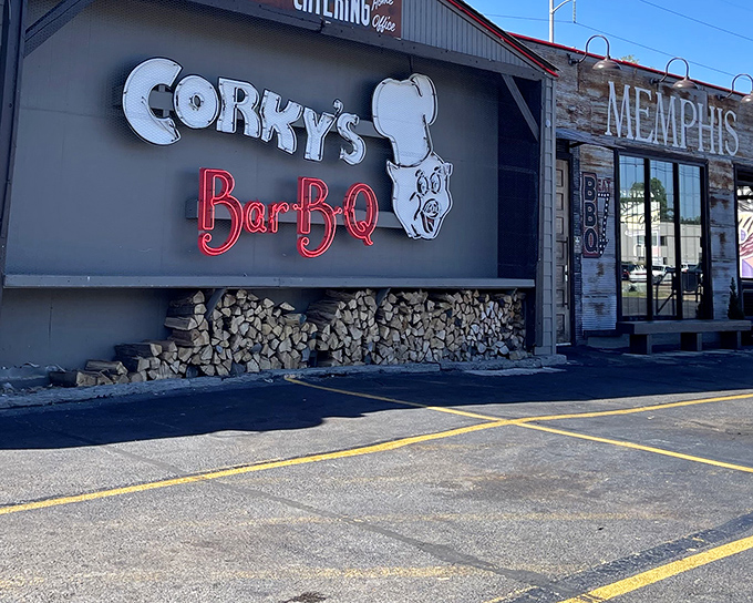 That iconic neon pig sign isn't just calling you in—it's promising a religious experience. The stacked hickory wood below isn't decoration; it's the secret weapon.