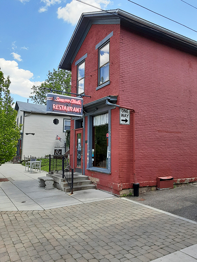 The iconic red brick exterior of Sam and Ethel's stands like a beacon of breakfast hope on Tipp City's Main Street, promising comfort inside those unassuming walls.