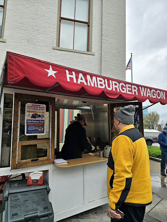 That red awning waves like a culinary flag of surrender – resistance is futile when burgers call.