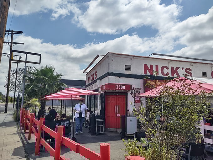 The iconic white building with bold red trim stands like a time capsule on North Spring Street, beckoning hungry Angelenos with its no-nonsense charm.