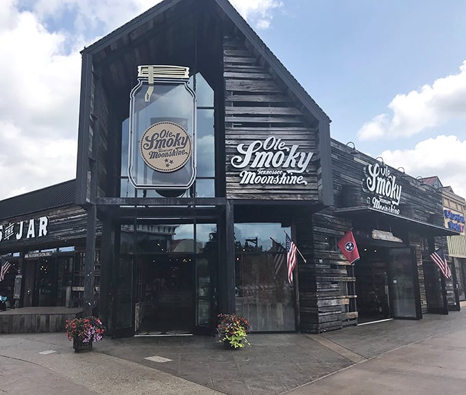 Welcome to moonshine paradise! The rustic wooden facade of Ole Smoky's "The Holler" invites visitors into a world where mountain traditions flow as freely as their spirits.