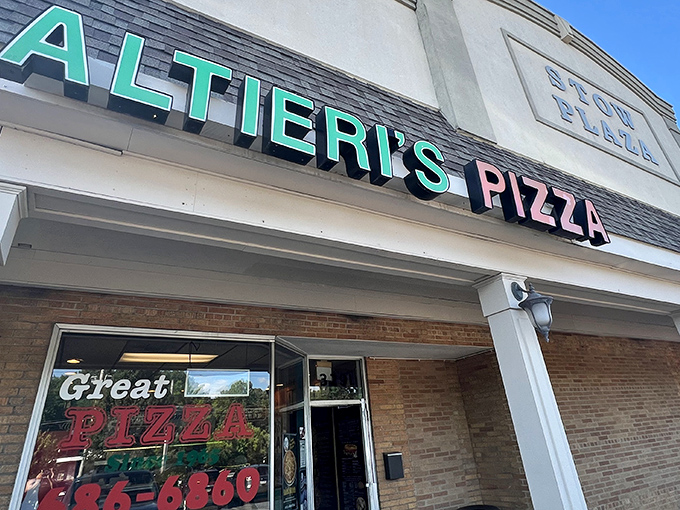 The iconic turquoise and pink sign beckons pizza lovers like a neon lighthouse guiding hungry sailors to the shores of flavor paradise.