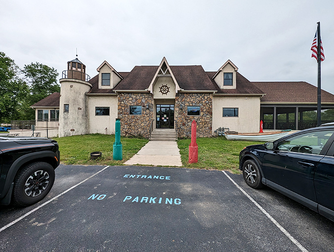 The lighthouse-inspired exterior of Kathy's Crab House stands as a beacon to seafood lovers, promising maritime treasures within those stone-faced walls.