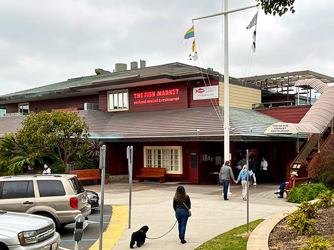The Fish Market's nautical exterior stands like a welcoming lighthouse for hungry seafood pilgrims. Those flags aren't just for show&mdash;they're signaling "fresh catch ahead!"