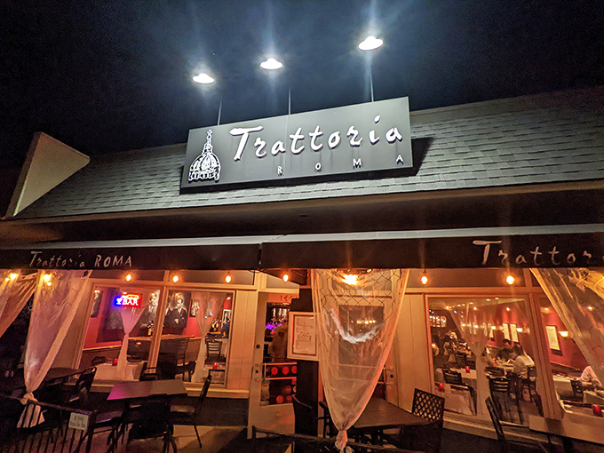 The evening glow of Trattoria Roma beckons like a lighthouse for the pasta-starved, promising Italian salvation behind those flowing curtains.