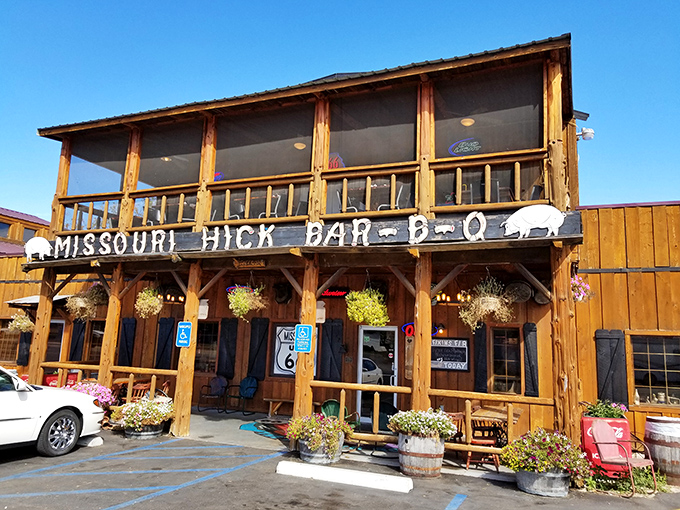 The rustic wooden facade of Missouri Hick Bar-B-Q stands proudly along Route 66, like a barbecue beacon calling hungry travelers home.