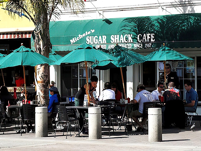 The iconic teal awning of Sugar Shack Cafe welcomes hungry beachgoers with the promise of comfort food and ocean breezes. A California classic hiding in plain sight.