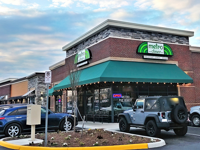 Metro Diner's inviting exterior beckons with its signature green awning and warm brick facade. Like a lighthouse for the hungry, it promises comfort in every bite.