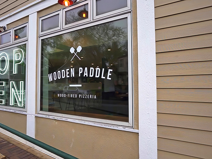 The unassuming yellow exterior of Wooden Paddle hides culinary treasures within, like finding a Michelin-worthy meal in your neighbor's kitchen.