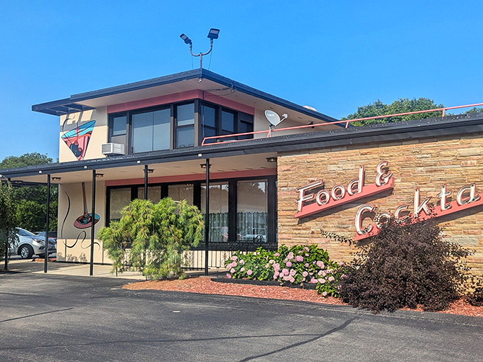 The mid-century stone facade of HOBNOB stands proudly against the Wisconsin sky, its "Food & Cocktails" sign promising delicious memories in the making.