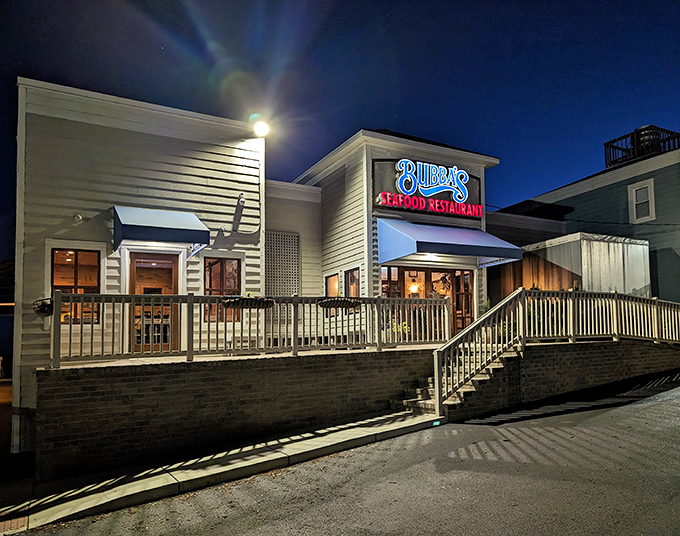 Bubba's glows like a beacon for seafood lovers at twilight, its weathered white exterior and welcoming deck promising maritime delights within.