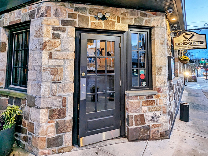The stone facade of Bridgets Steakhouse stands like a culinary fortress in Ambler, promising treasures within that the modest exterior only hints at.