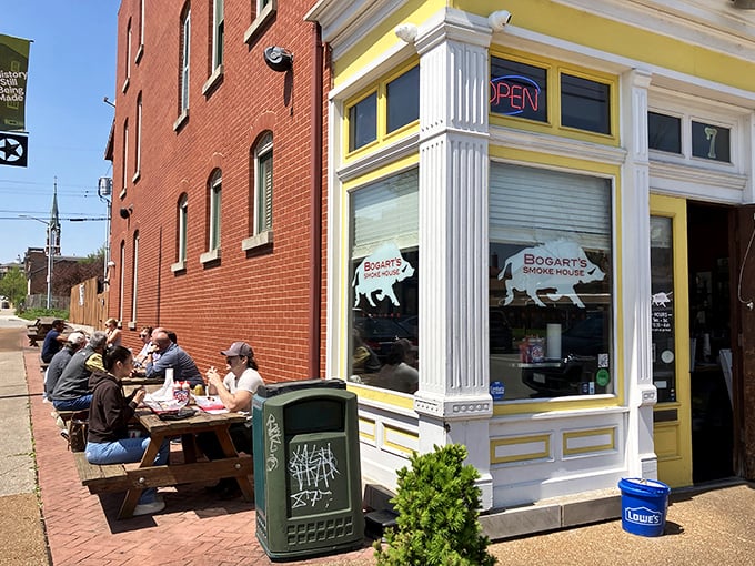 The bright yellow trim of Bogart's Smokehouse beckons like a BBQ lighthouse in Soulard, with picnic tables ready for the feast ahead.