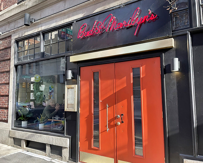 Those iconic red doors aren't just an entrance &ndash; they're a portal to comfort food paradise. Bud & Marilyn's neon sign glows like a beacon for hungry Philadelphians.