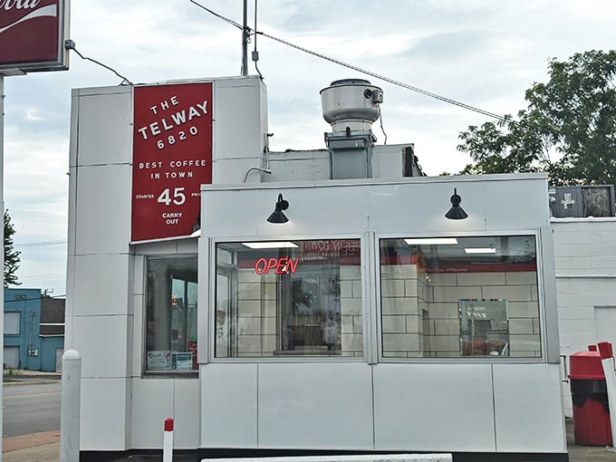 The iconic Telway sign stands as a beacon of hope for hungry travelers, promising "4 HAMBURGERS" like it's the answer to life's most pressing question.