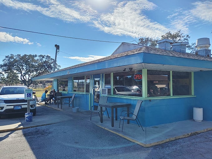 The bright blue exterior of Shep's Diner stands out like a beacon of breakfast hope against the Florida sky, promising culinary comfort inside.