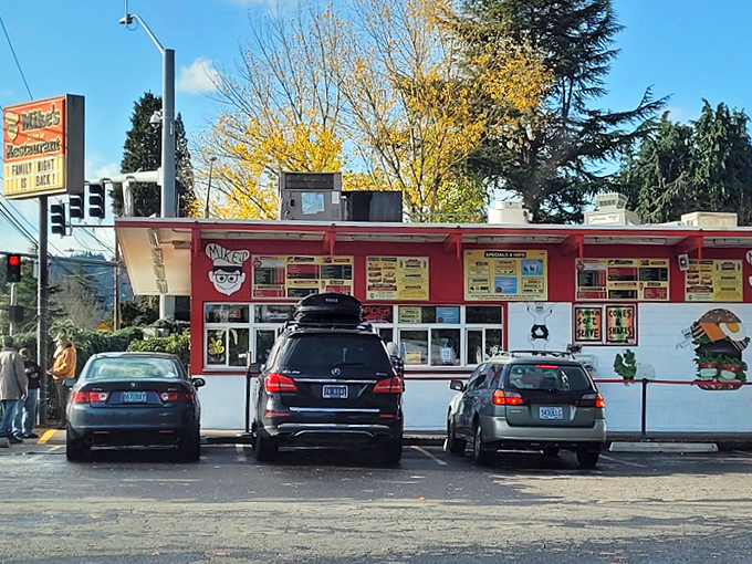 The bright red exterior of Mike's Drive-In stands as a beacon of burger hope in Milwaukie, where nostalgia meets hunger in perfect harmony.