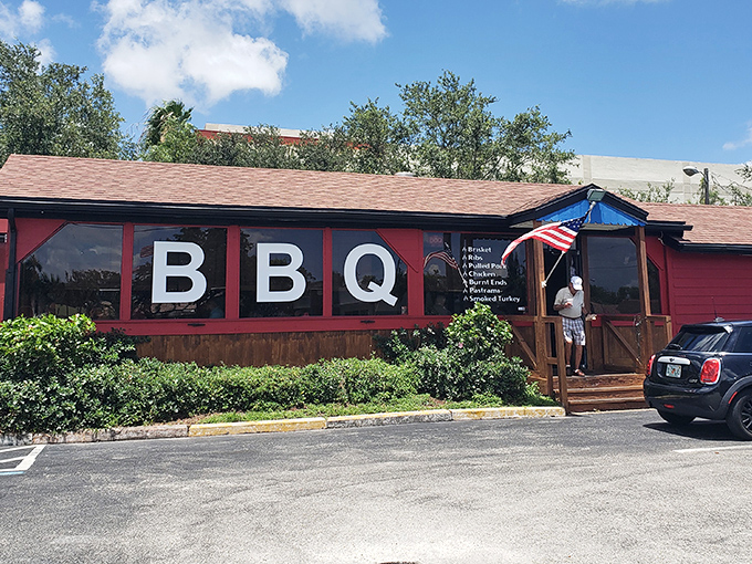 The red building with "BBQ" boldly displayed isn't just announcing its presence&mdash;it's making a solemn promise your taste buds won't soon forget.