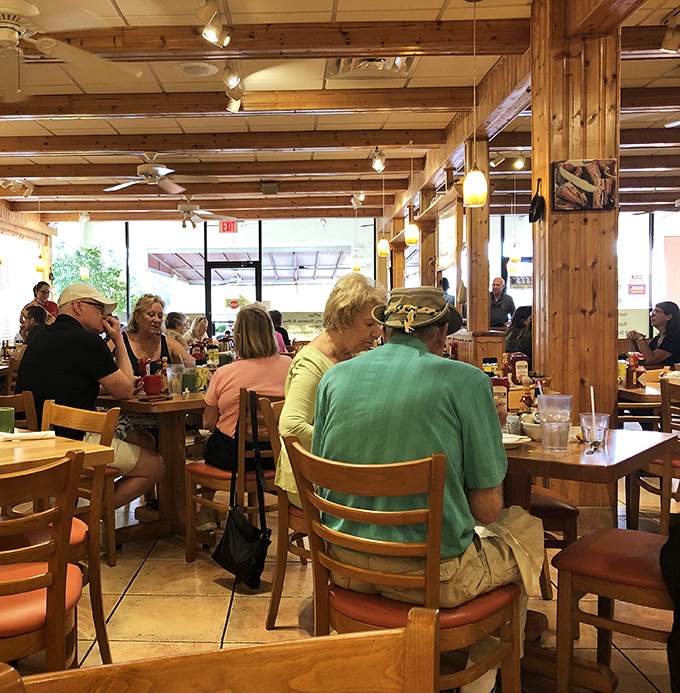 The bustling interior of Skillets speaks volumes – wooden beams overhead, happy diners below, and breakfast magic happening everywhere in between.