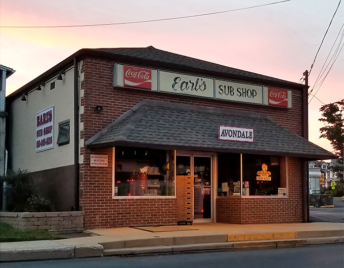 The sunset glow on Earl's brick facade isn't just pretty lighting&mdash;it's nature's way of highlighting where sandwich magic happens in Avondale.