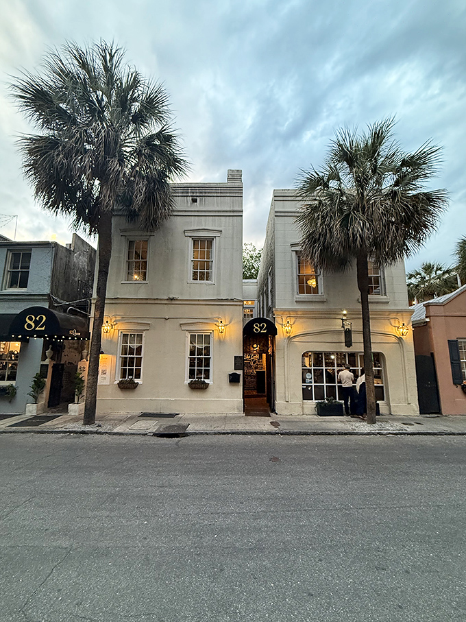 The elegant facade of 82 Queen stands proudly on its namesake street, palm trees swaying like Southern sentinels welcoming hungry visitors.