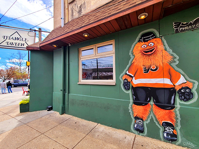 The iconic green exterior of Triangle Tavern, complete with Gritty mural, welcomes hungry Philadelphians like an old friend with new tricks.