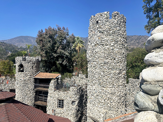 Stone towers rise against the California sky like medieval sentinels guarding a suburban kingdom. Who needs European castles when Glendora has this masterpiece?