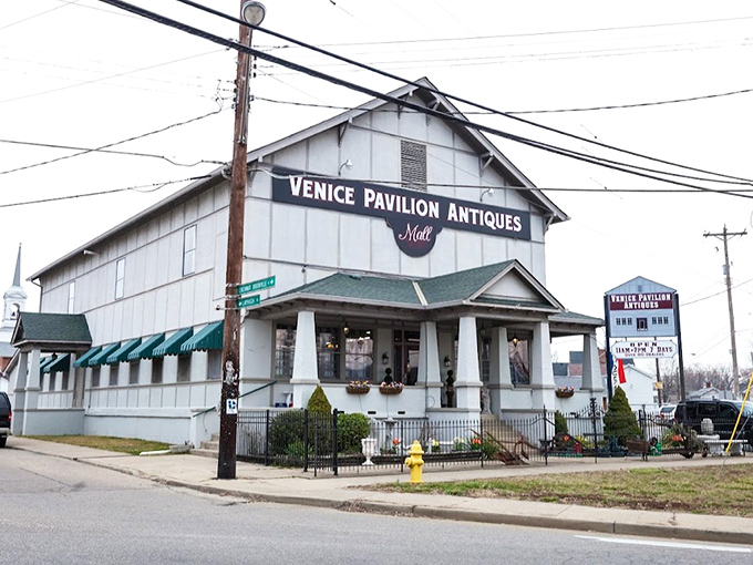 The white clapboard exterior of Venice Pavilion Antiques stands like a time capsule on the corner, promising treasures within that HGTV stars would battle over.