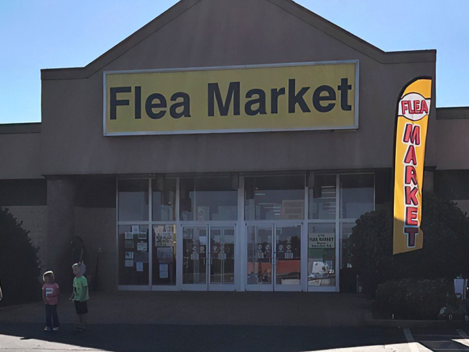 The unassuming yellow sign beckons like a treasure map's X-marks-the-spot. Behind these doors, bargain hunters find their paradise.