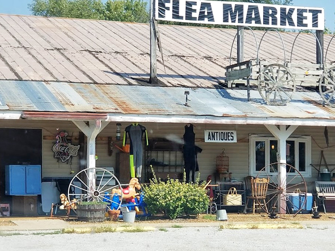 The weathered tin roof and rustic "FLEA MARKET" sign aren't just decoration—they're a promise of treasure hunting adventures waiting inside.