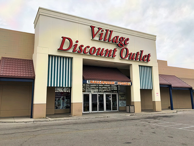 The iconic red signage of Village Discount Outlet stands like a beacon of bargain hope against the Ohio sky.