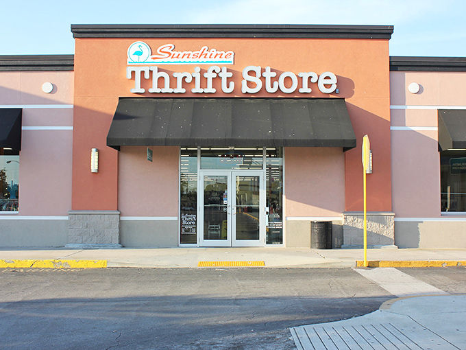 The coral-colored facade of Sunshine Thrift Store beckons bargain hunters like a retail oasis in the Florida sun.