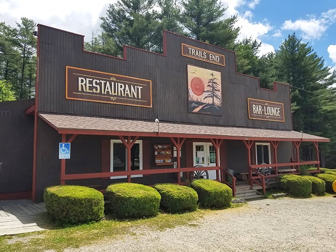 The frontier-style facade of Trail's End stands proudly among towering pines, like a delicious mirage appearing just when your hunger hits its peak.