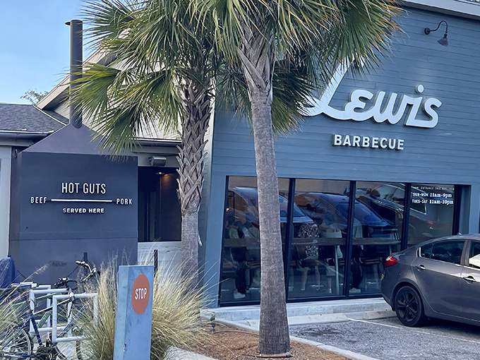 The blue exterior of Lewis Barbecue stands like a smoke-scented beacon in Charleston, with palm trees providing that perfect Southern frame for meat pilgrims.