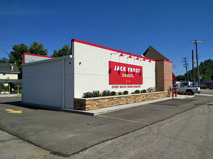 The white building with bold red signage stands like a beacon of sweetness on Pearl Road, promising "EVERY BATCH FRESH SCRATCH" &ndash; the donut lover's siren call.