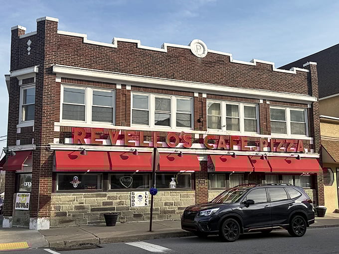 The brick facade and bright red awnings of Revello's stand as a beacon of comfort food in Old Forge, where pizza traditions run deeper than coal mines.