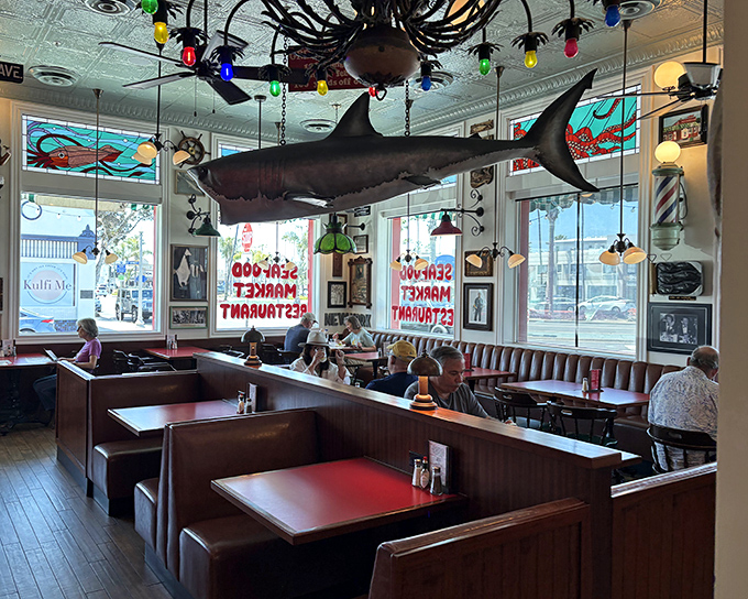 The iconic fire-engine red exterior of The Crab Cooker, complete with its famous "DON'T LOOK UP HERE" fish sign, stands as Newport Beach's seafood beacon.