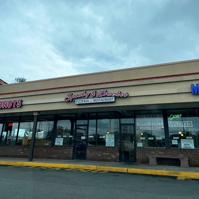 The unassuming storefront beckons with its neon-pink sign, promising Italian delights that far exceed its strip mall location's modest appearance.