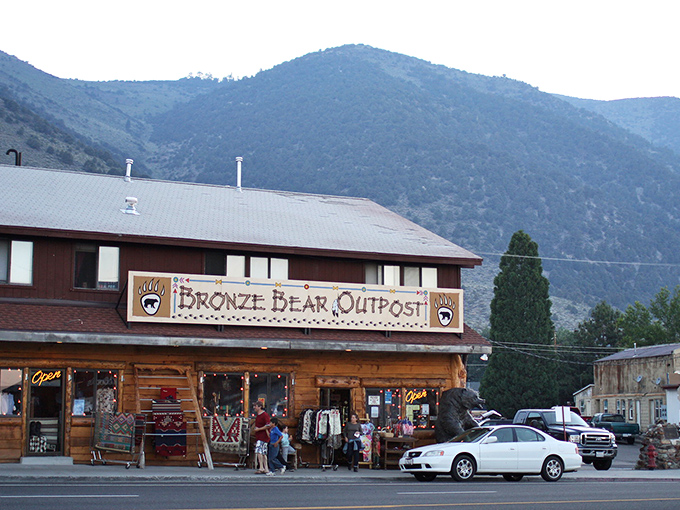 The Bronze Bear Outpost stands like a frontier trading post from another era, with mountains that make Manhattan's skyline look like amateur hour.