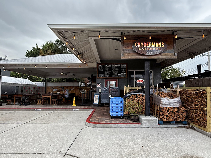 The pilgrimage begins here – an unassuming shrine to smoke and meat where stacked firewood isn't decoration, it's a promise of deliciousness to come.