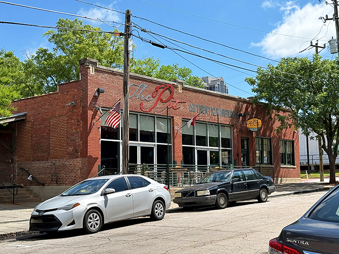 The brick exterior of The Pit stands like a temple to smoked meat, its unassuming fa&ccedil;ade hiding flavor explosions waiting to happen inside.