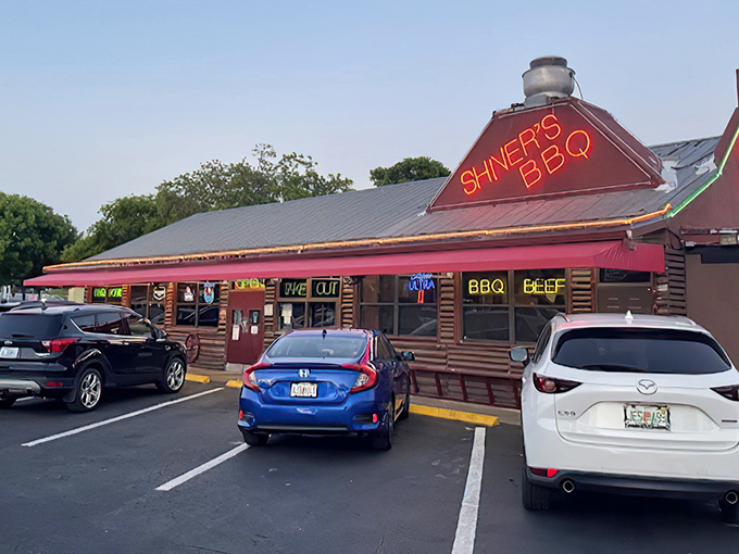 The neon glow of Shiver's BBQ sign is like a smoky lighthouse guiding hungry souls to barbecue paradise. No fancy frills, just the promise of meaty delights within.
