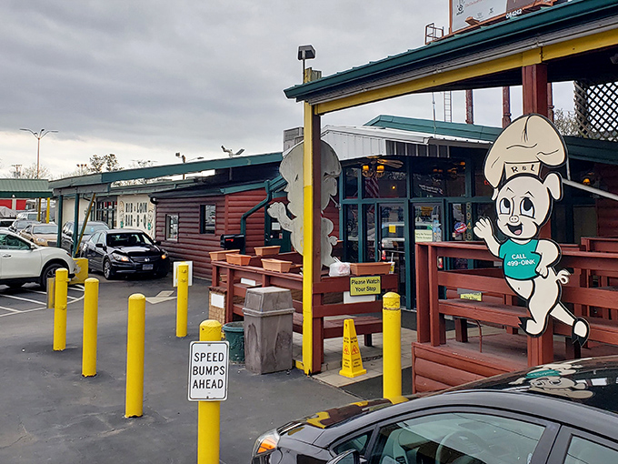 The unassuming exterior of Rib & Loin, where those cheerful cartoon pigs seem to be saying, "Come on in, the barbecue's fine!" Don't let the modest facade fool you.