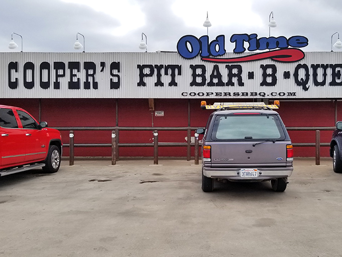 The iconic red exterior of Cooper's Old Time Pit Bar-B-Que stands like a beacon to meat lovers across Texas Hill Country.