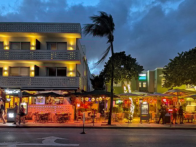 Ocean Drive comes alive at dusk as News Cafe's warm lights beckon hungry travelers and locals alike. Miami's iconic sidewalk dining scene at its finest.