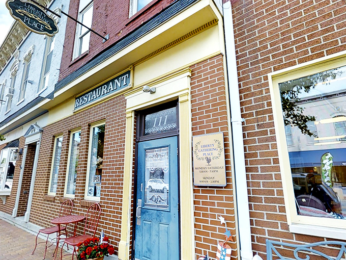 The blue door beckons like an old friend, promising comfort and calories in equal measure. Liberty Gathering Place's brick exterior whispers "come on in" to hungry travelers. 