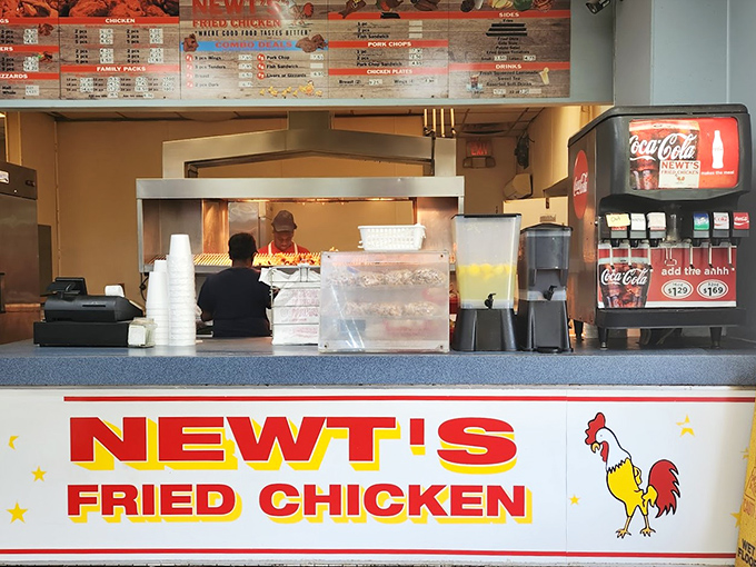 The bright red Newt's Fried Chicken sign promises salvation for the hungry soul. Simple counter service, maximum flavor delivery.